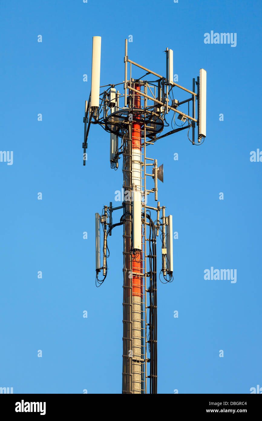 Cellular communication tower on blue sky background Stock Photo - Alamy