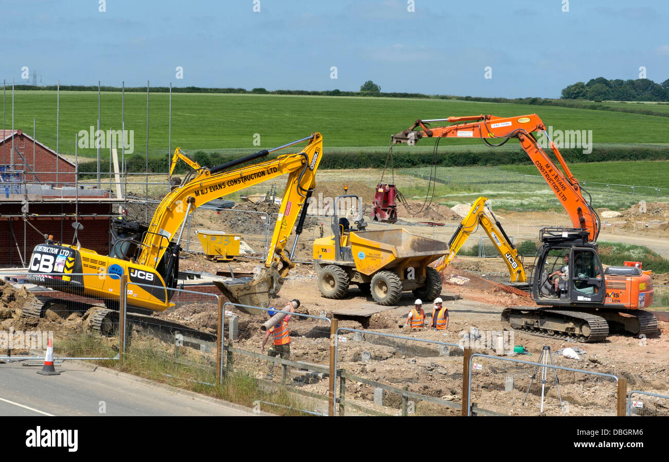 Heavy plant machinery preparing land for residential housing estate ...