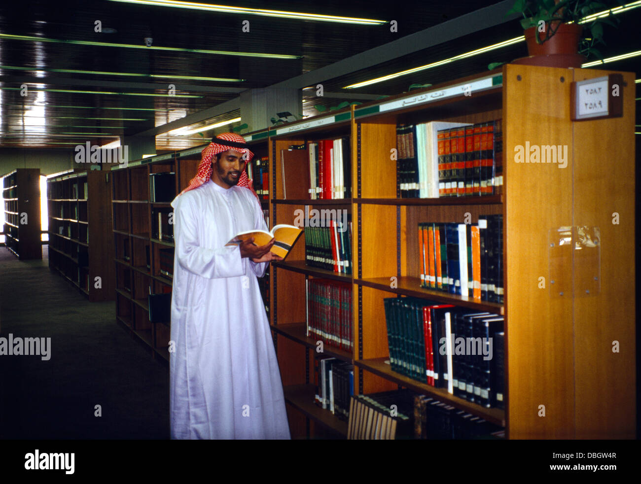 Abu Dhabi UAE Cultural Centre Man Reading Book In Library Stock Photo ...