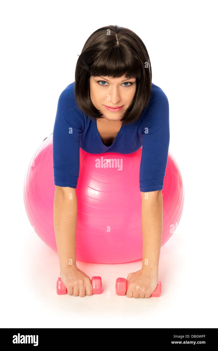 Exercises with dumbbells on a gymnastic ball Stock Photo - Alamy