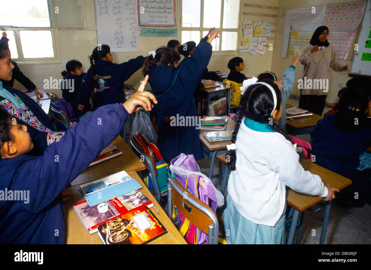 Kuwait Children In Class With Their Hands Up Stock Photo - Alamy
