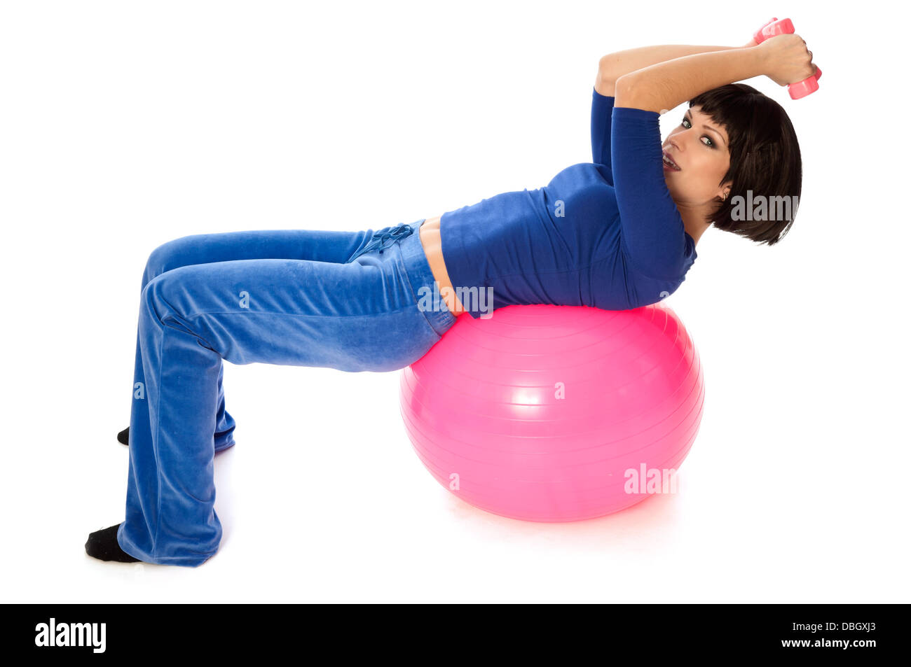 Exercises with dumbbells on a gymnastic ball Stock Photo - Alamy