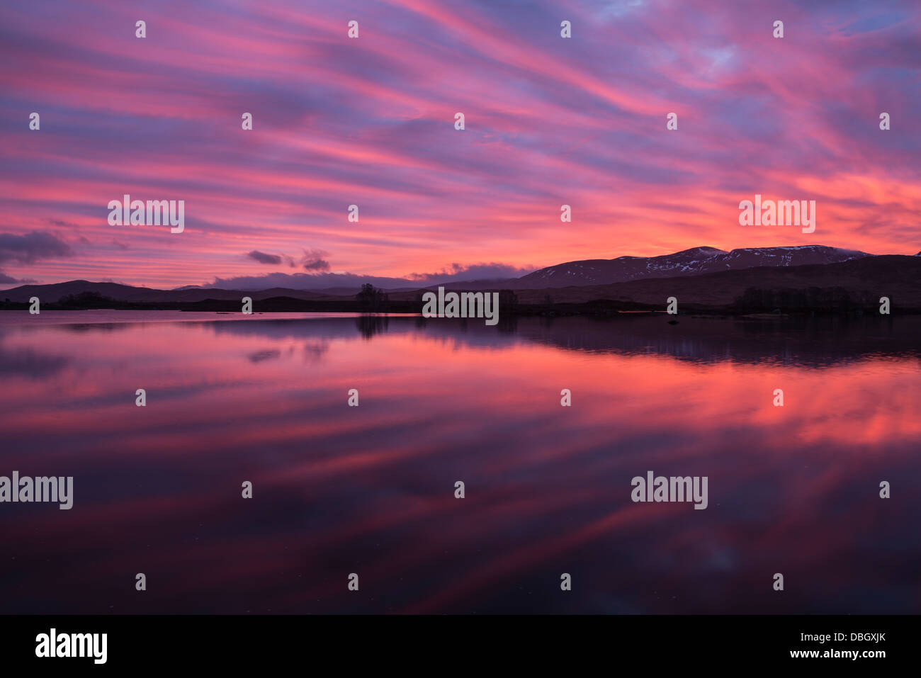 Spectacular pink sunrise reflection on Loch Ba, Rannoch Moor, Highland ...