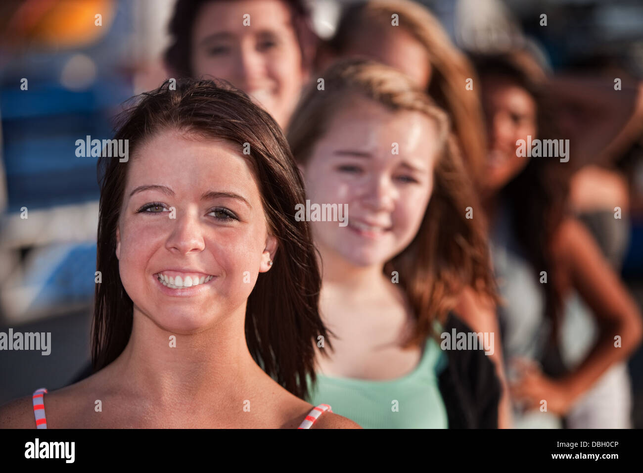 Happy Teenage Girls in a Row Stock Photo - Alamy