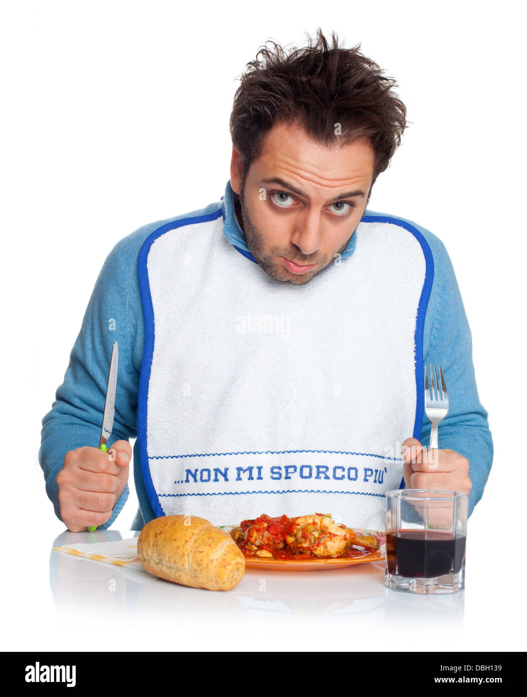 Guy with bib at the dinner table Stock Photo - Alamy