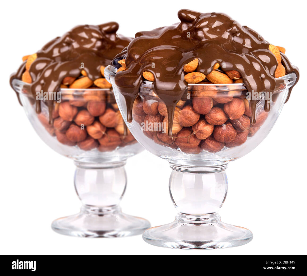 Chocolate Flowing over nuts in a glass Isolated on White - Tasty look ...