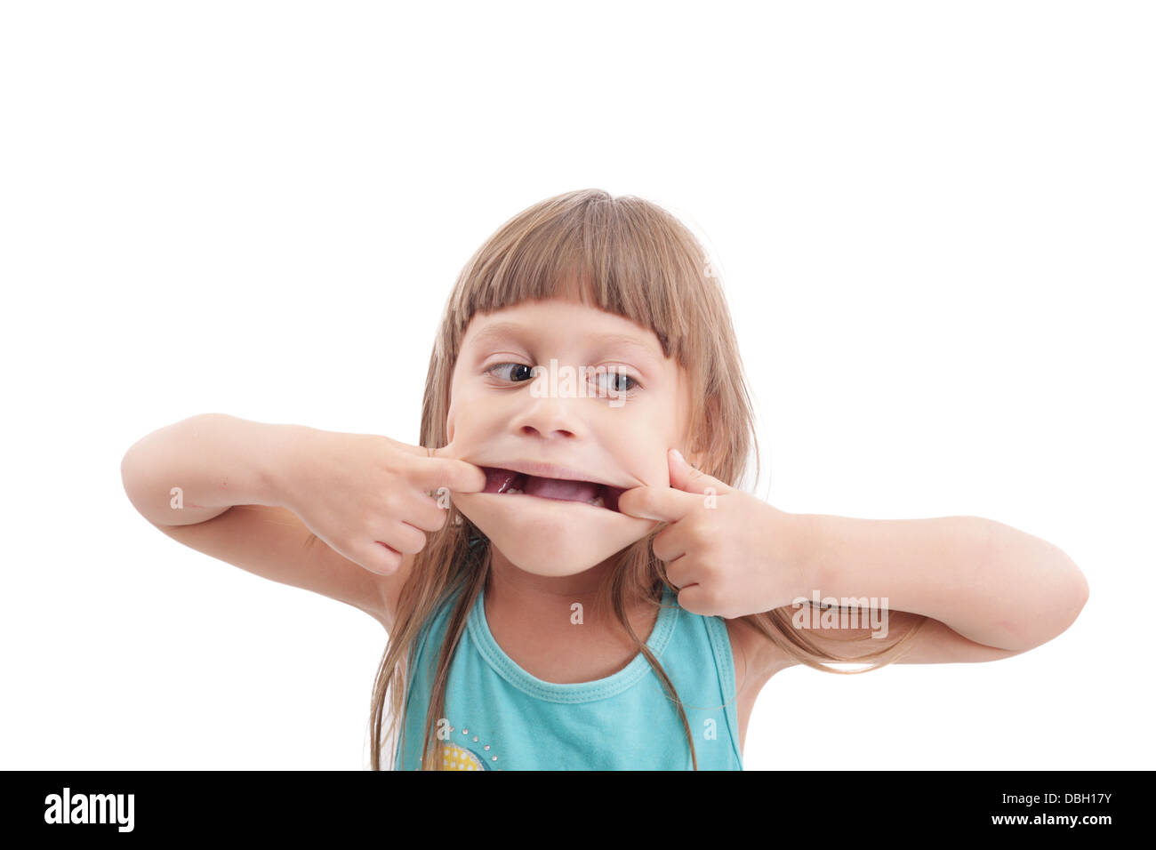Little girl making a strange face on white background Stock Photo - Alamy