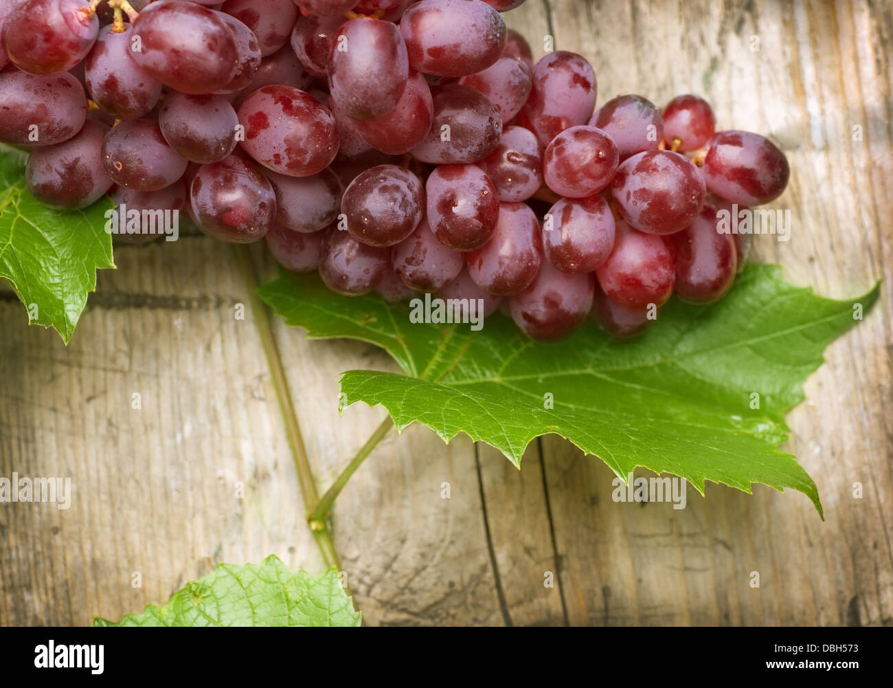 Bunch of grapes over Wood Background Stock Photo - Alamy