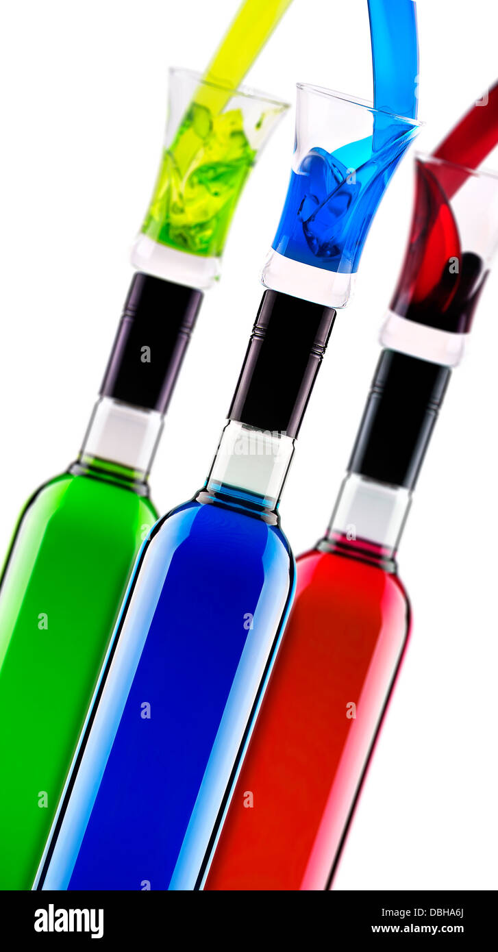 full bottles of different multicolored alcoholic cocktails with glass ...