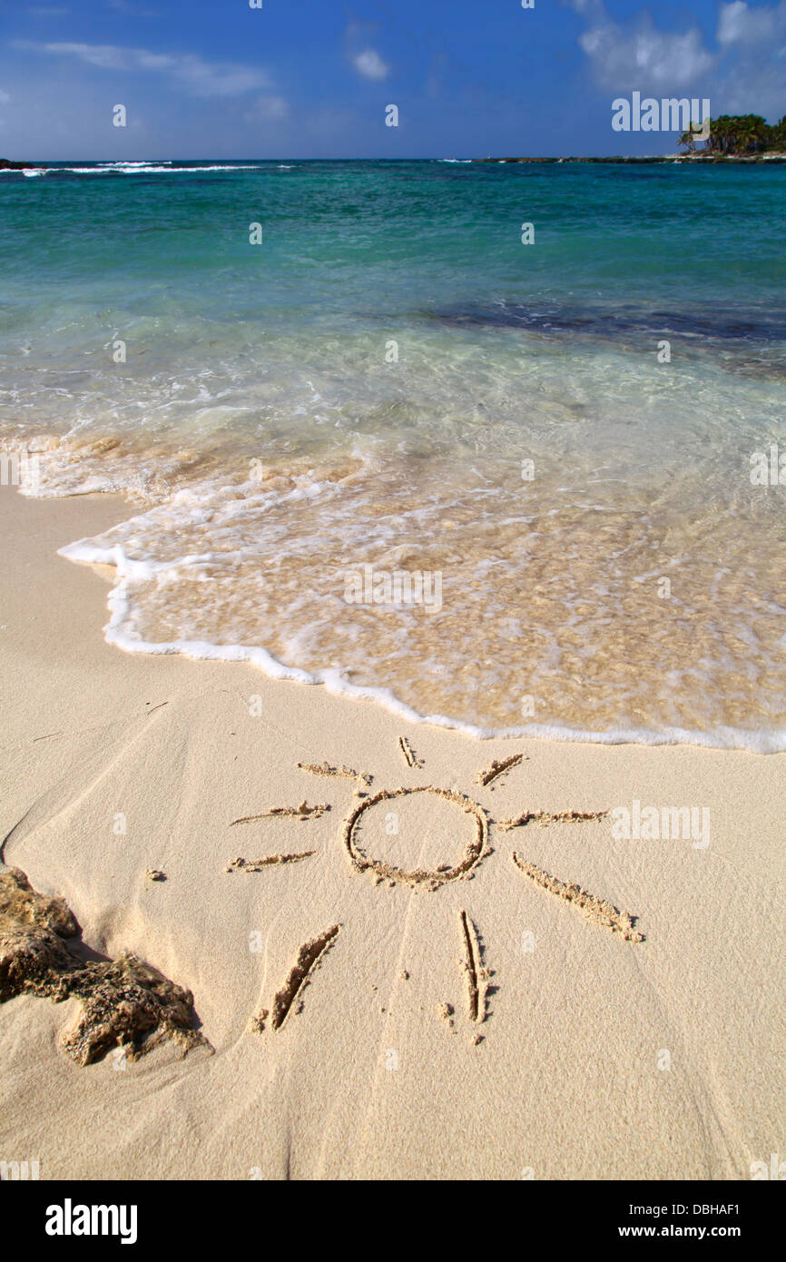 The drawing of the sun on the beach sand on the blue sea and sky ...