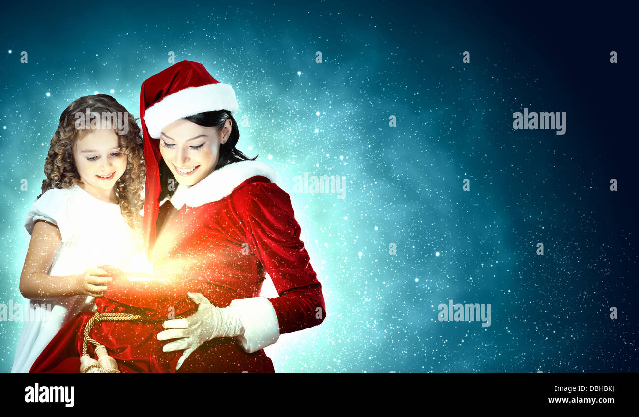 Little girl with christmas gifts and santa Stock Photo - Alamy