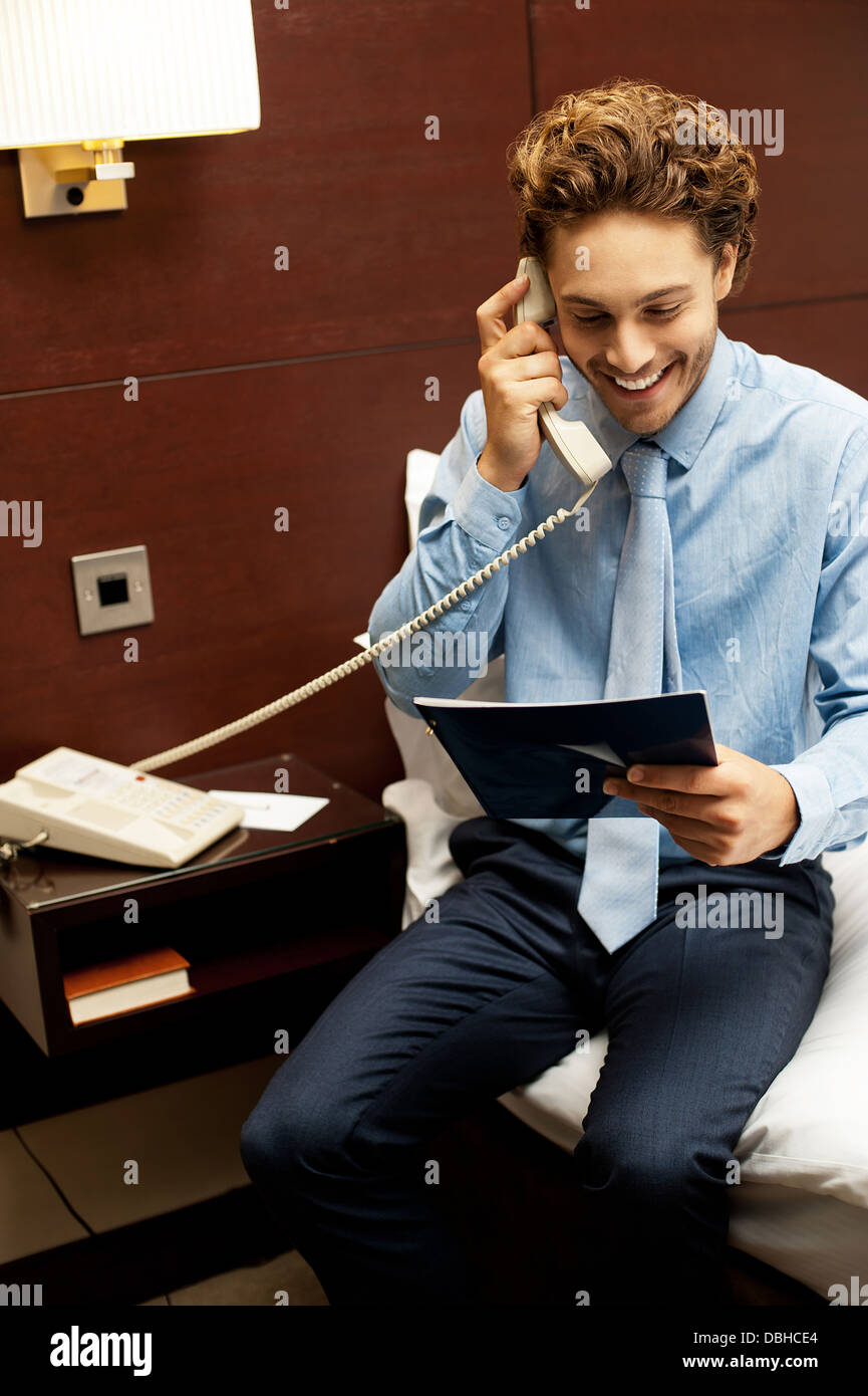 Smiling gentleman placing an order over the phone Stock Photo - Alamy