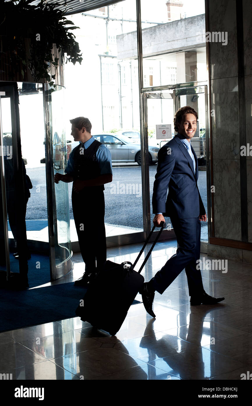 Caucasian guest walking towards the reception Stock Photo - Alamy
