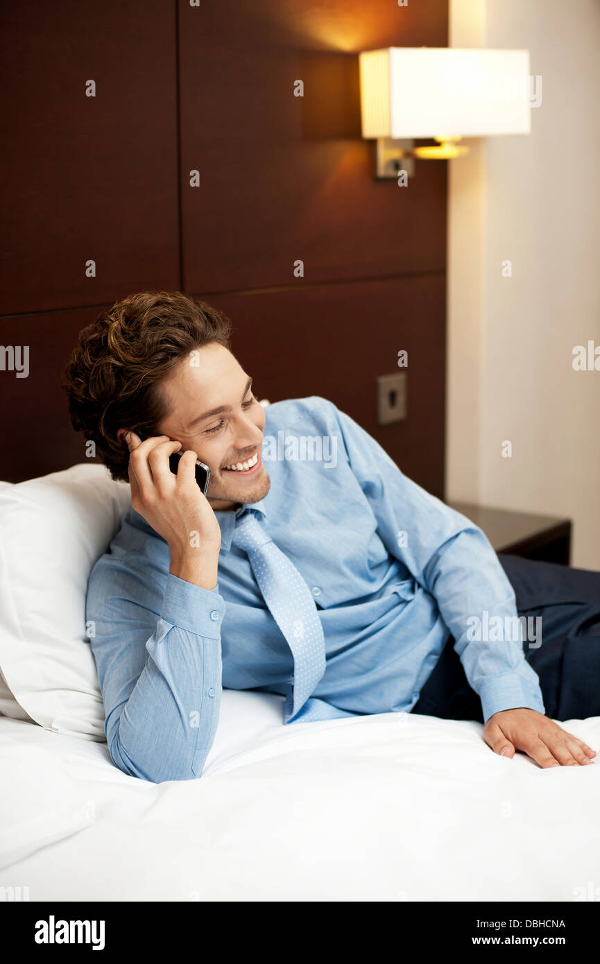 Delighted young man communicating with his partner Stock Photo - Alamy