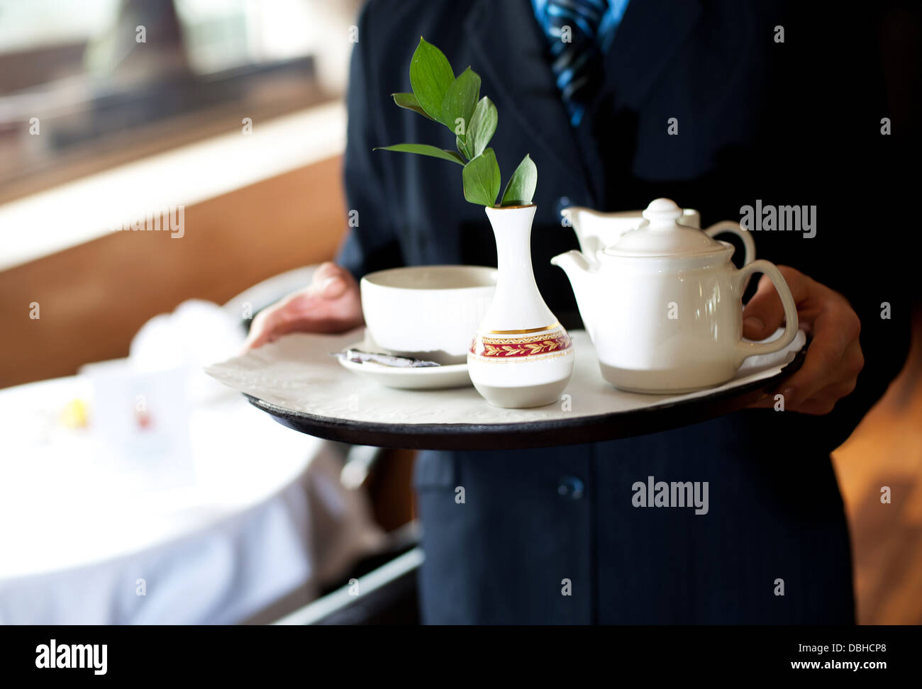 Cropped image of man carrying tea tray Stock Photo - Alamy