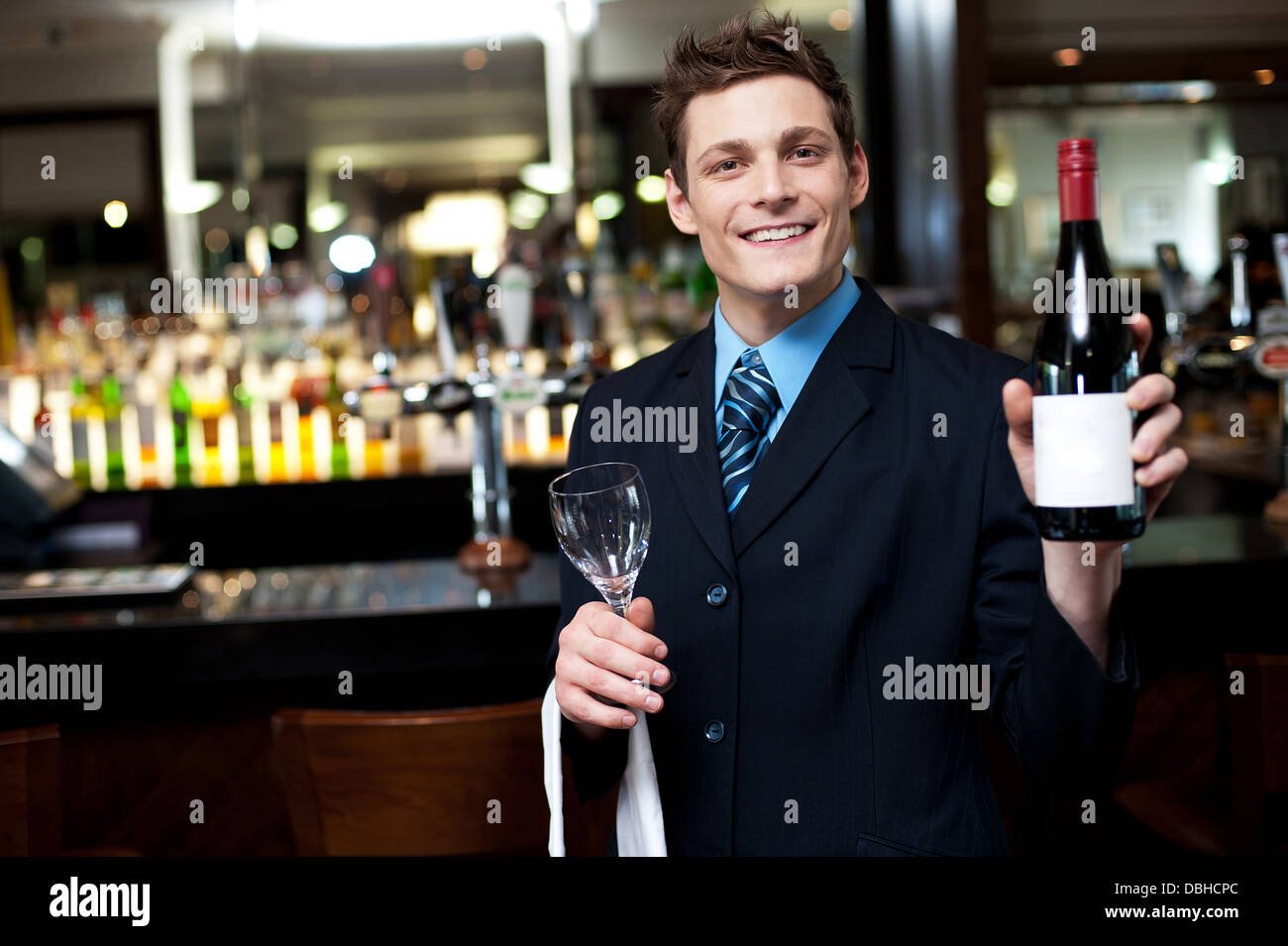 Cheerful executive posing with a bottle of wine Stock Photo - Alamy