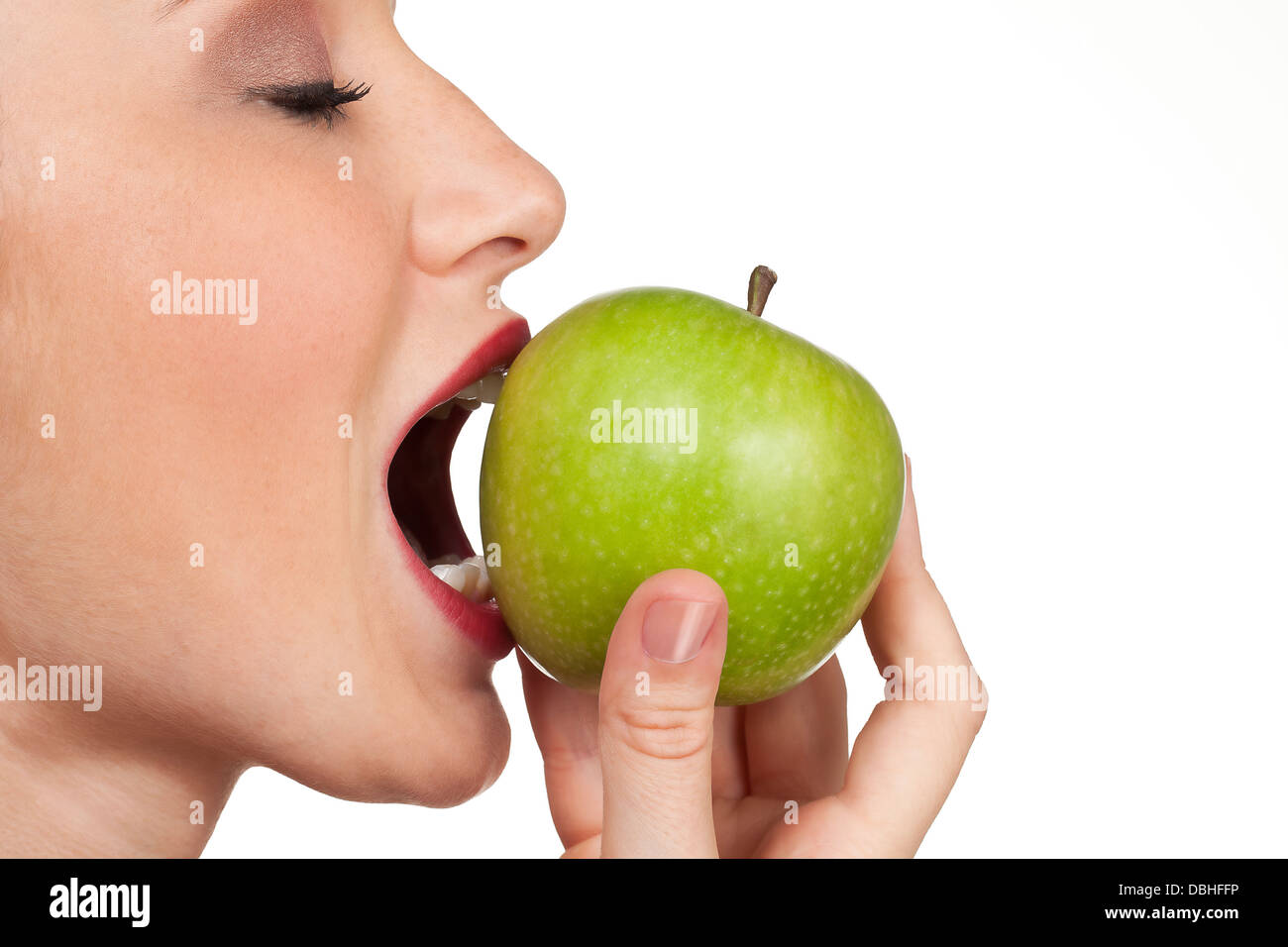 women biting into fresh apple closeup on white background Stock Photo ...