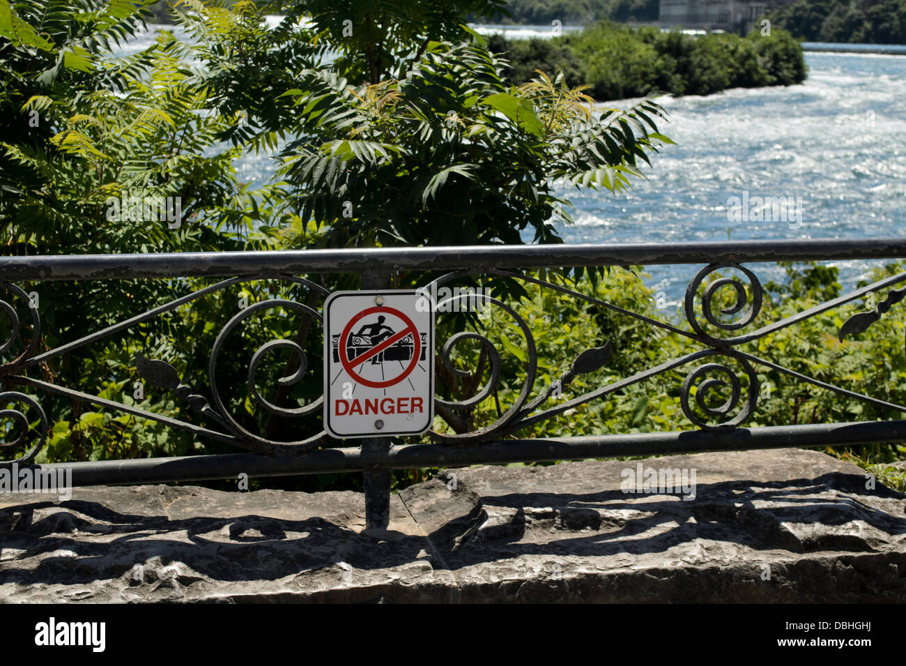 Warning sign against climbing over railing of Niagara river near the ...