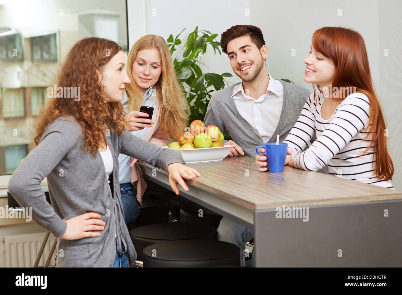 Creative business team taking a break in social room Stock Photo - Alamy