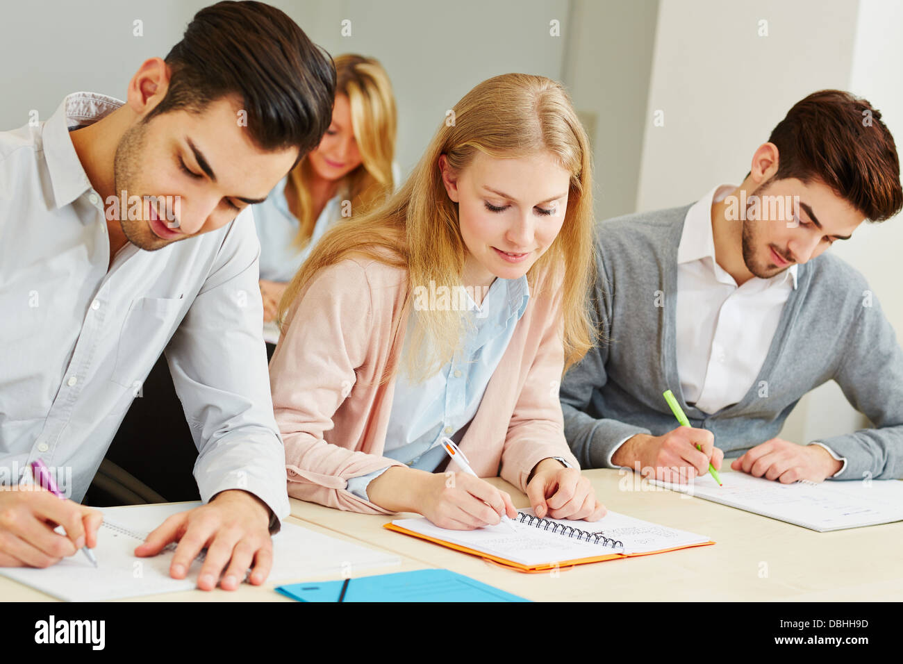 Group of students studying together in university class Stock Photo - Alamy