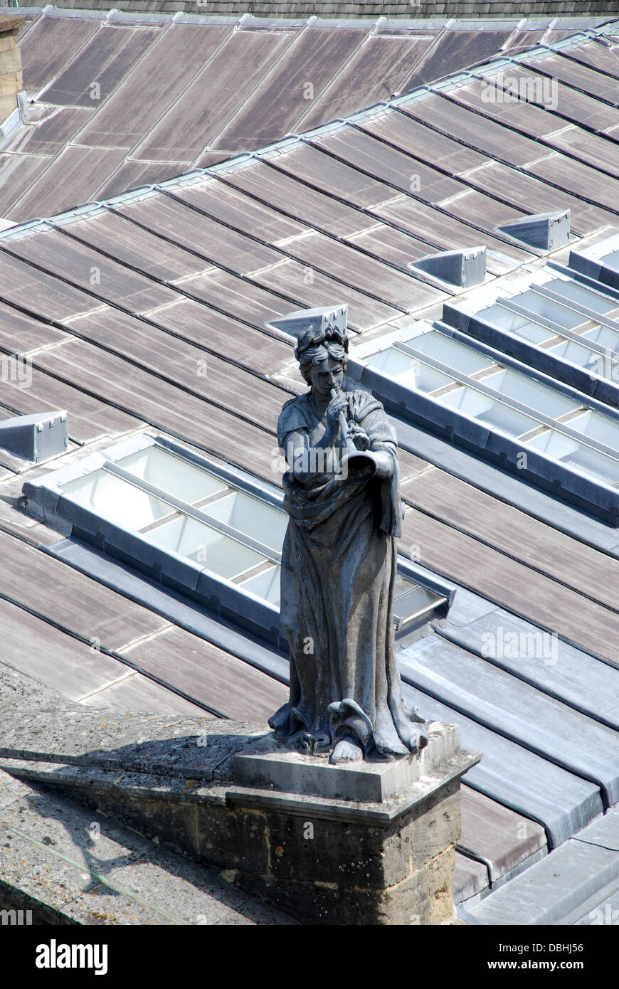 Statue of a woman blowing a horn on top of the Clarendon Building ...