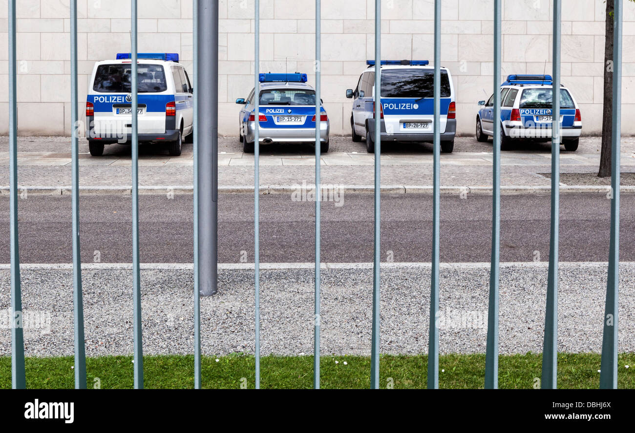 Four police vehicles parked at the side of the Chancellery building ...