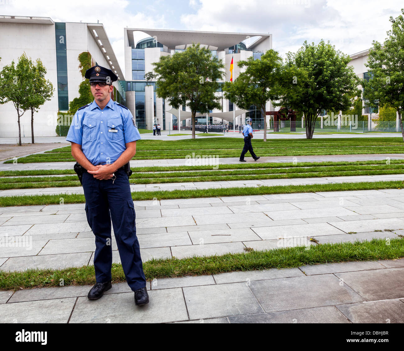A German police officer stands in front of the new glass and concrete ...