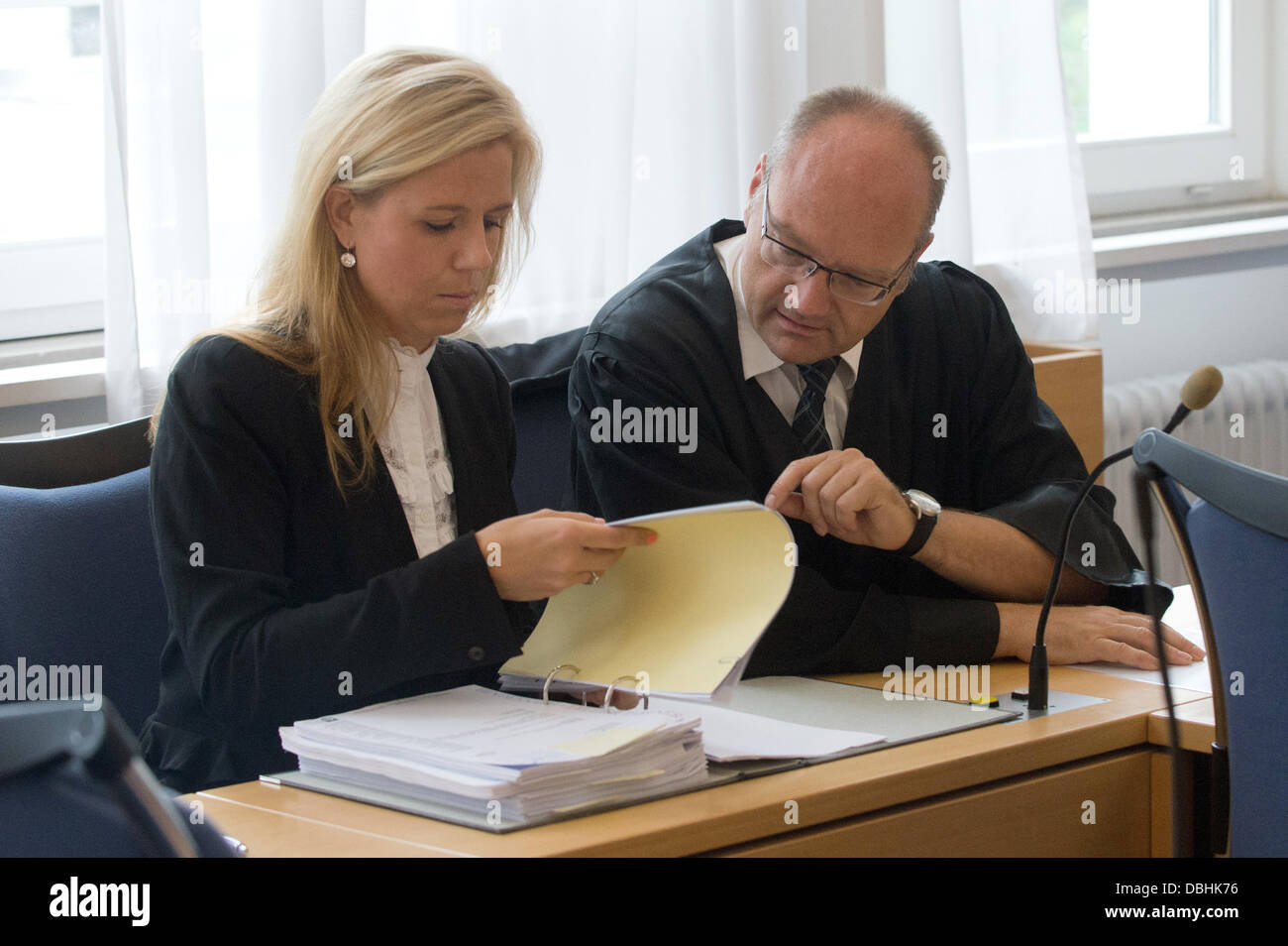 The lawyer of the defendant, Lena Brandt and Erik Silcher, talk in a ...