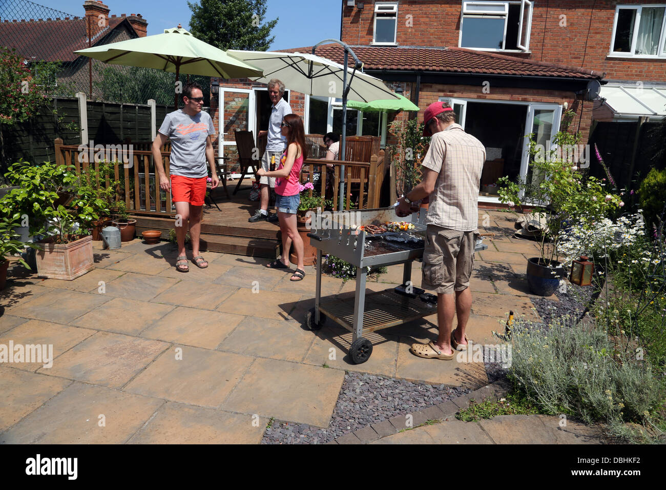 Family Having A Barbeque In Garden During The Summer Birmingham West ...