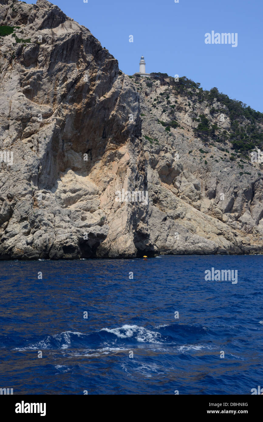 Wave and tiny boat with yellow roof, Formentor peninsula lighthouse ...