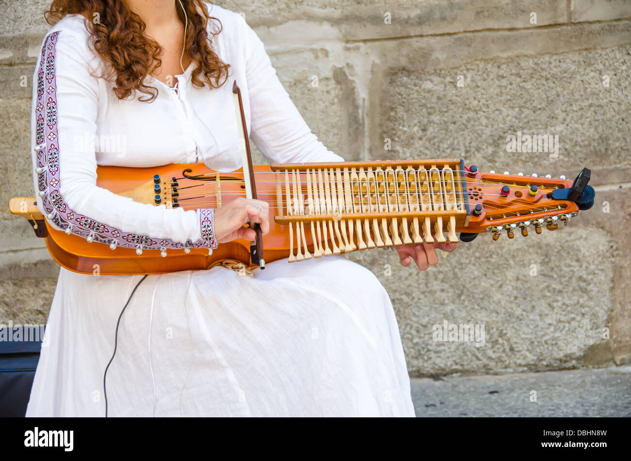 Woman Playing in the street a medieval instrument Stock Photo - Alamy