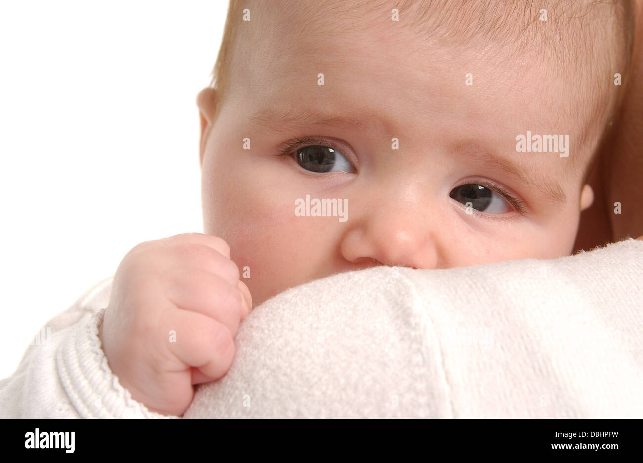 Baby girl looking over parents shoulder Stock Photo - Alamy