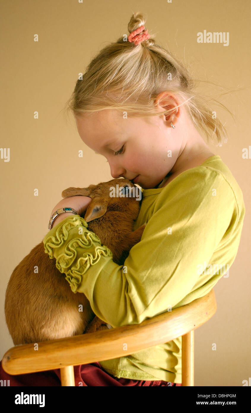 Little girl holding her rabbit Stock Photo - Alamy