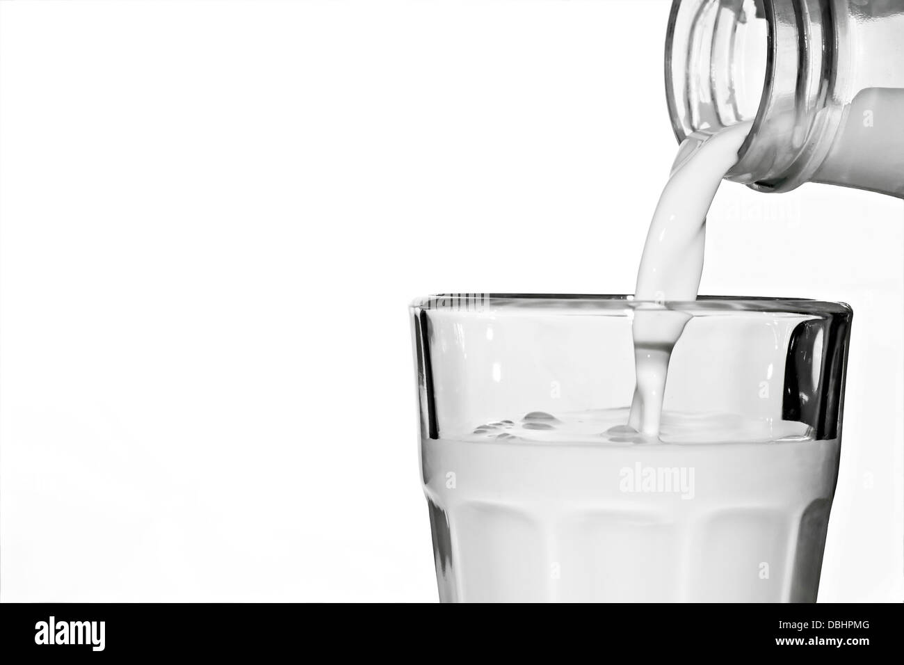 Milk being poured from a bottle into a glass Stock Photo - Alamy