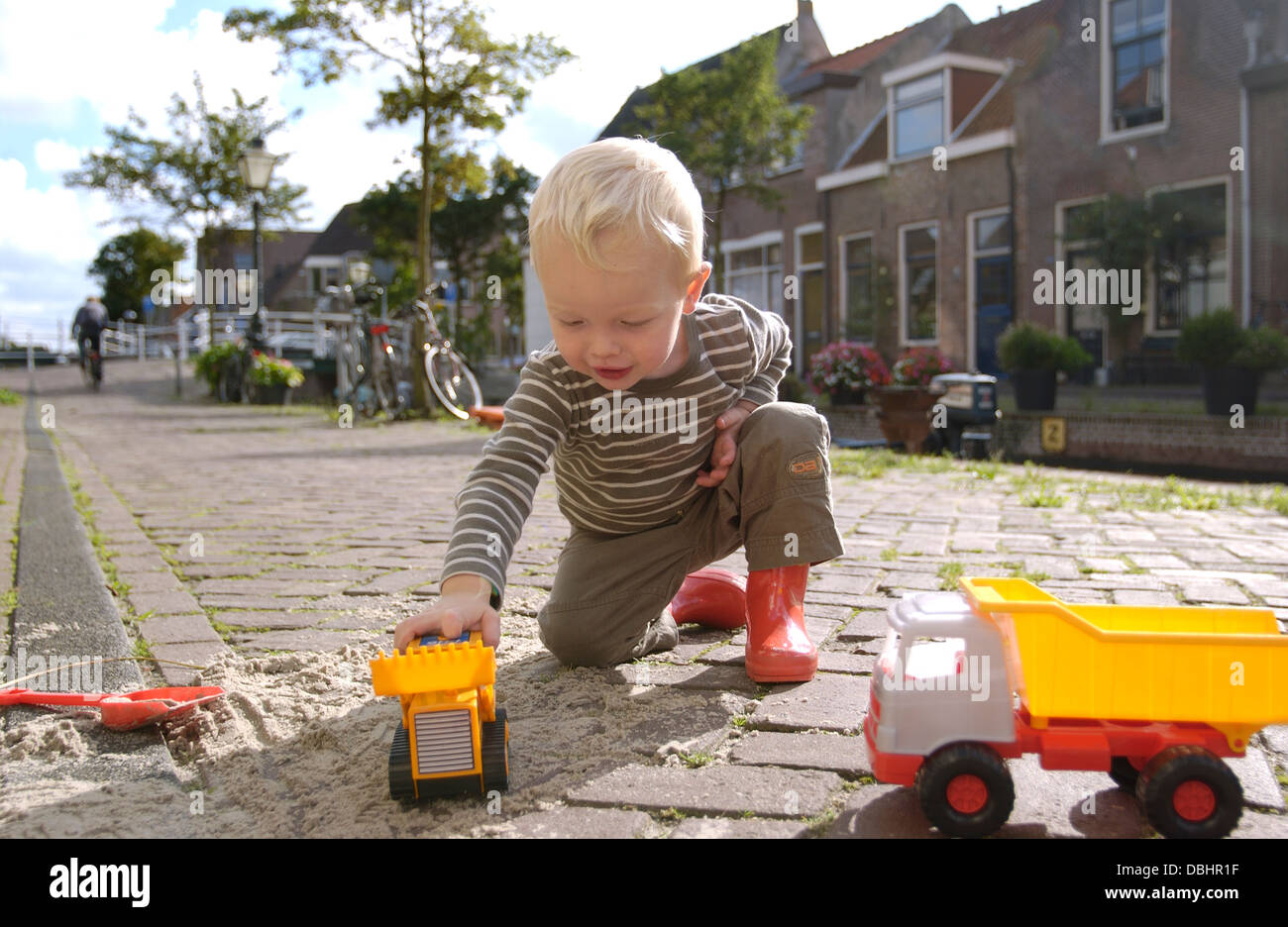 Little boy playing in the street Stock Photo - Alamy