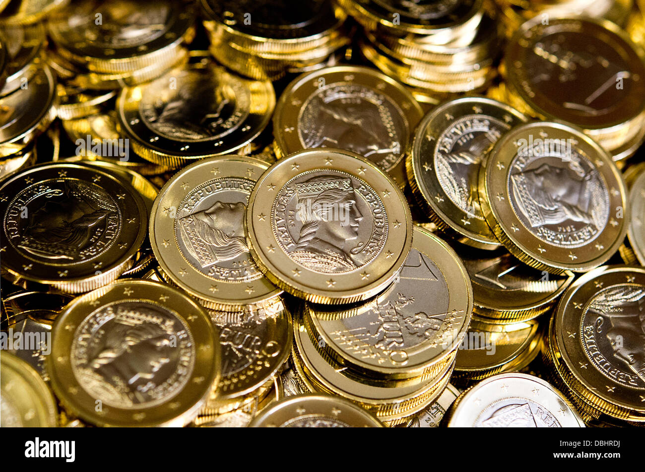 New Latvian two-euro coins lie in a trough in the state mint in ...