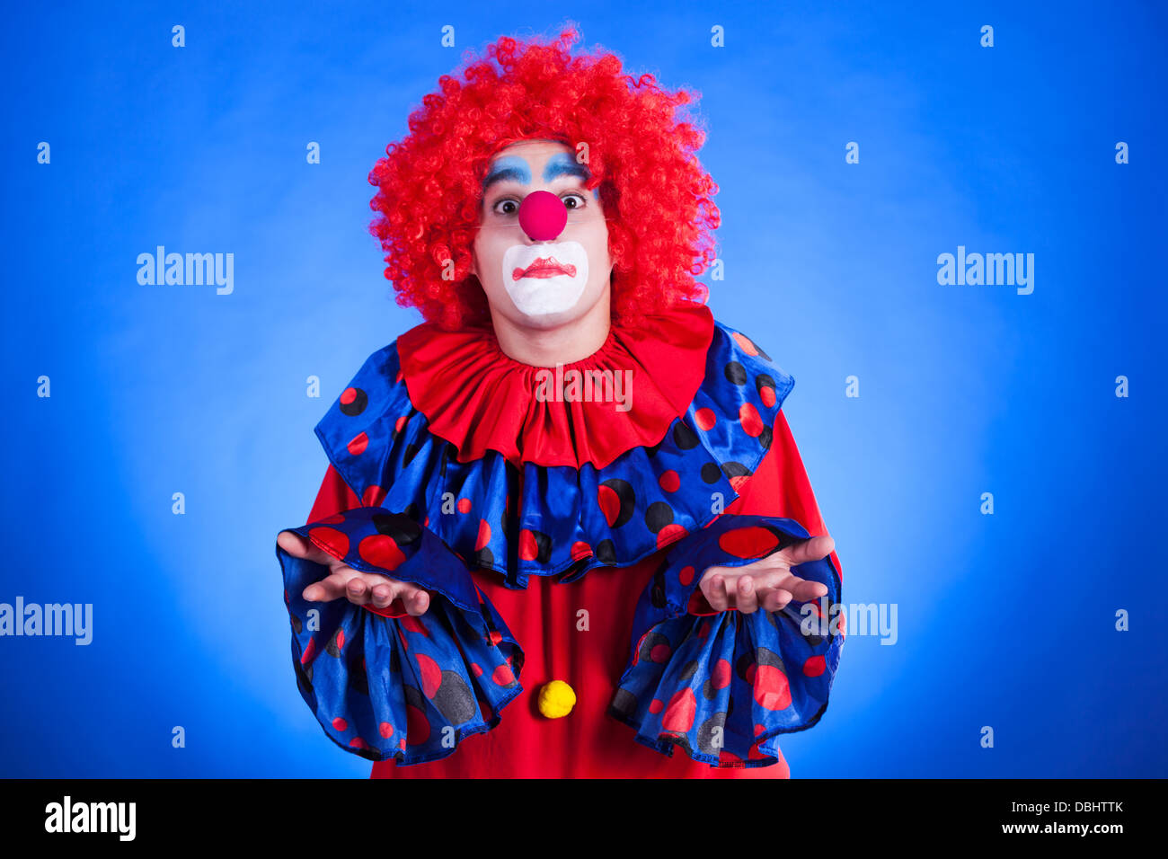 Clown on blue backgound studio inside shot Stock Photo - Alamy