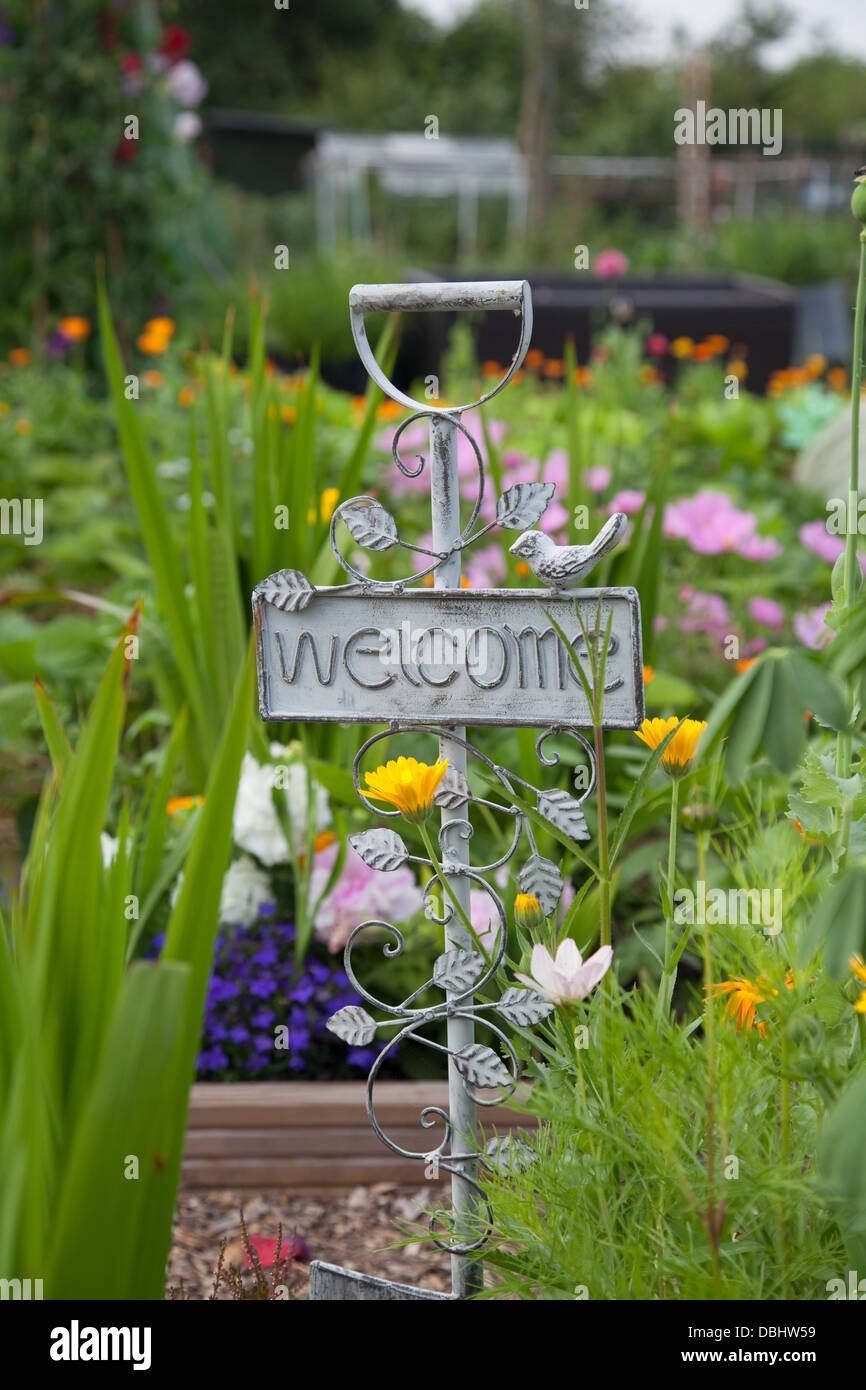 Welcome sign at urban allotment plot with flowers and vegetables Stock ...