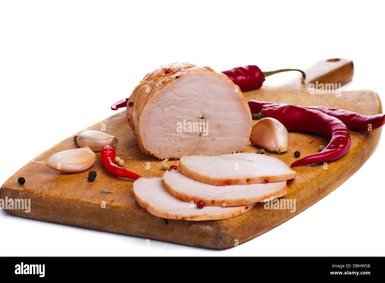 Homemade turkey ham with red chili peppers isolated Stock Photo - Alamy
