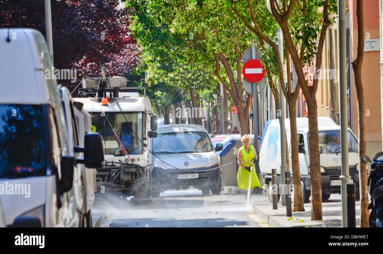 Street Cleaning. Municipal sweeper woman holding a water hose Stock ...