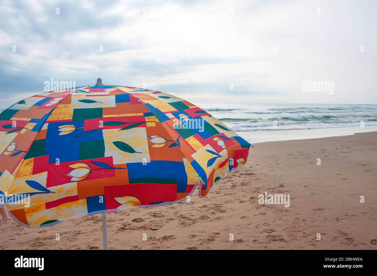Colorful Umbrella on the beach with no one in Gandia, Valencia Stock ...