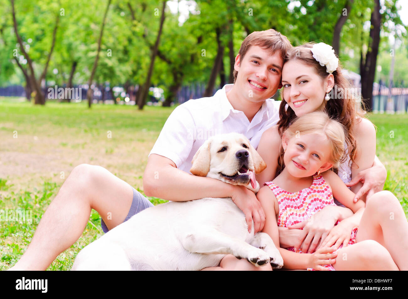 Happy young family with Labrador Stock Photo - Alamy