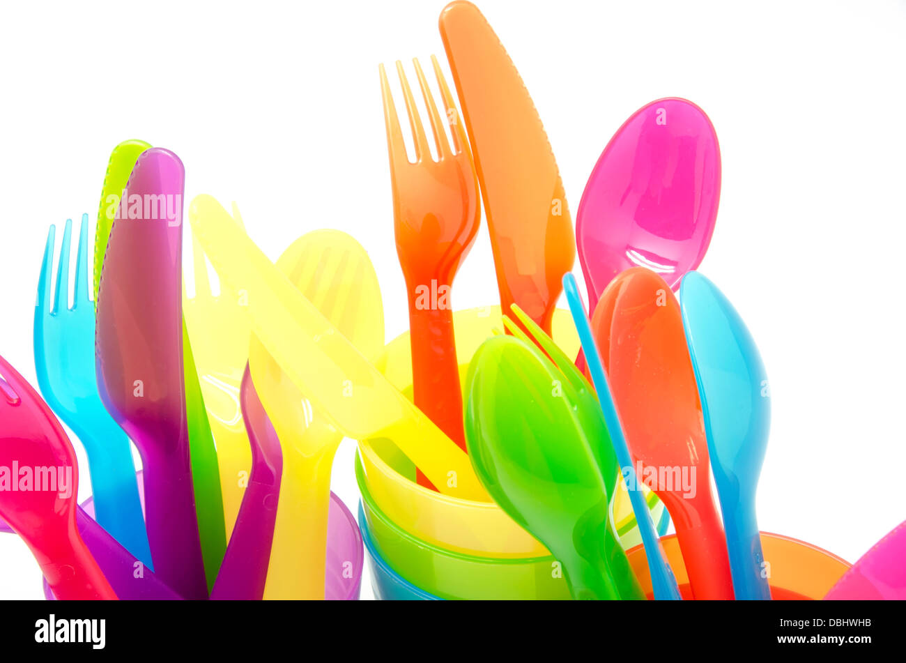 Plastic tableware of various colors on white background Stock Photo - Alamy