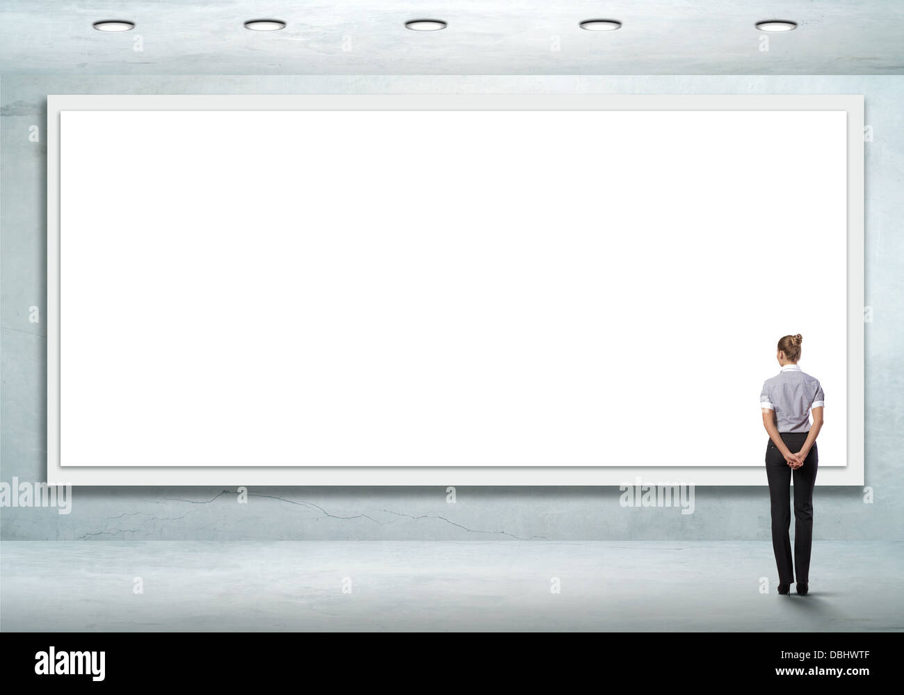 Business person standing near a blank billboard Stock Photo - Alamy