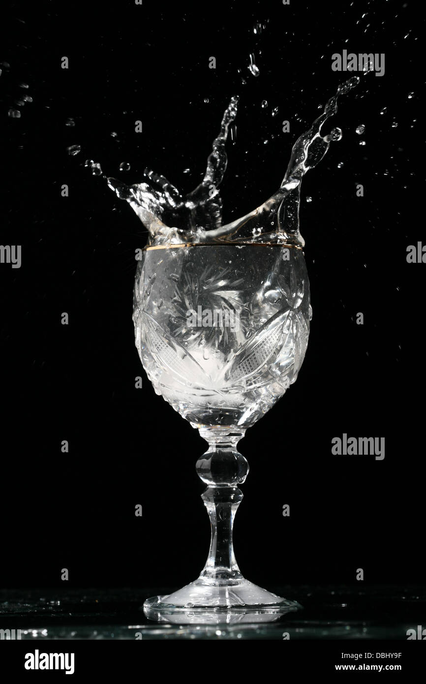 alcohol splash on black background Stock Photo - Alamy
