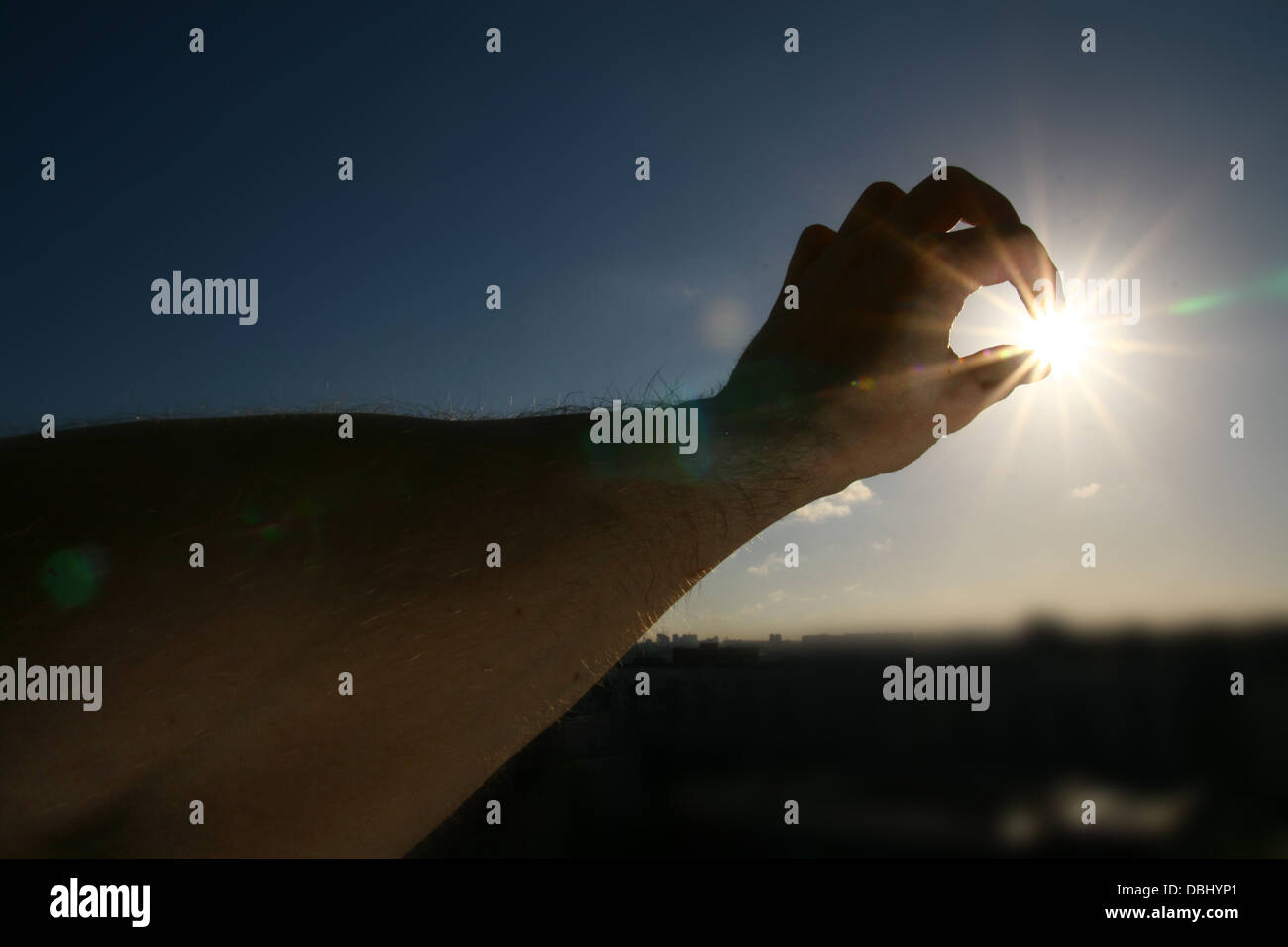 hand take the sun city in dark Stock Photo - Alamy