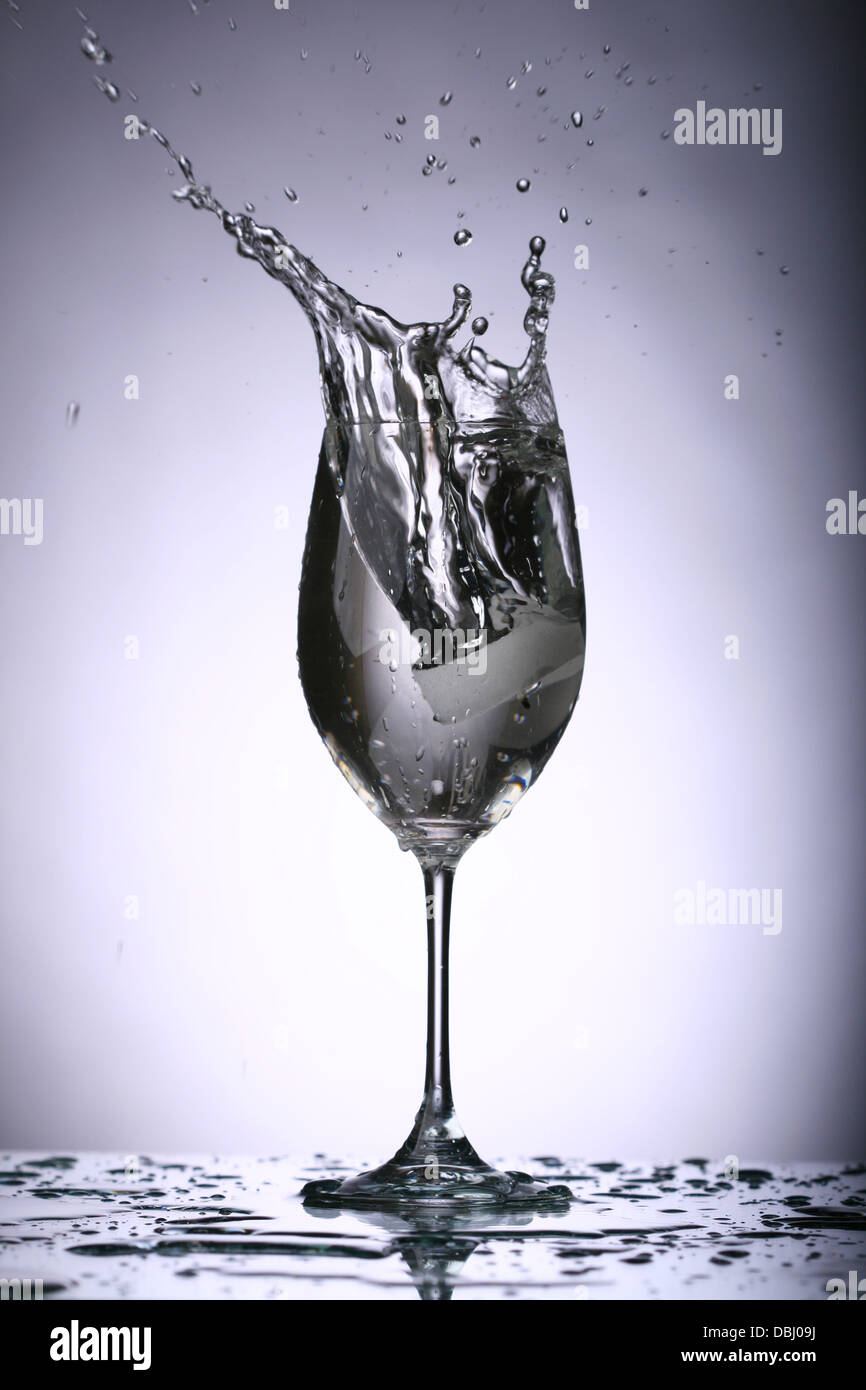 alcohol splash on gray background Stock Photo - Alamy