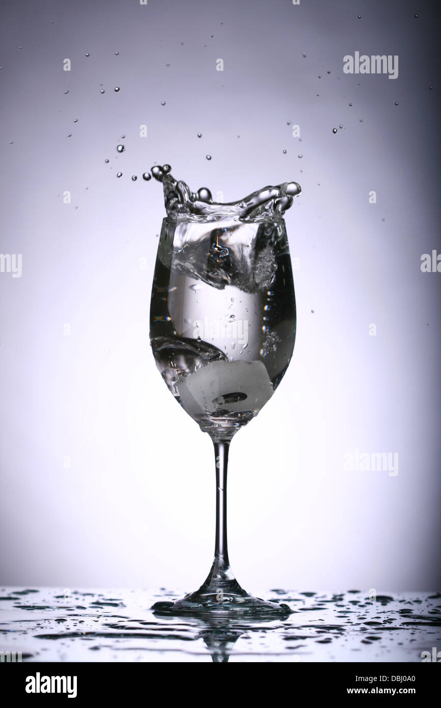 alcohol splash on gray background Stock Photo - Alamy