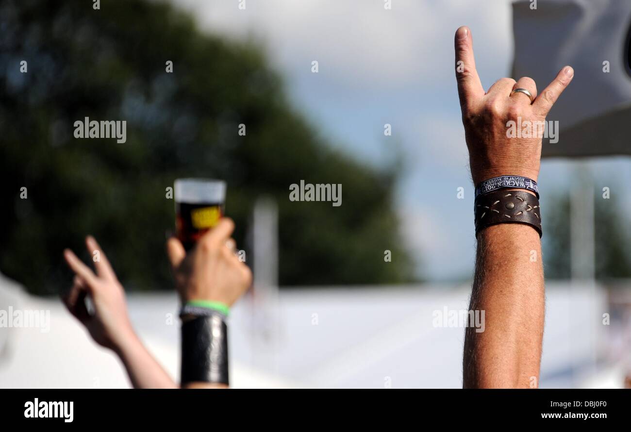 Wacken, Germany. 31st July, 2013. Festival visitors show the greeting ...
