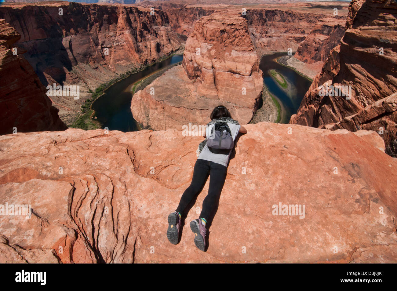 peering over the edge at Horseshoe Bend, famous meander of the Colorado ...